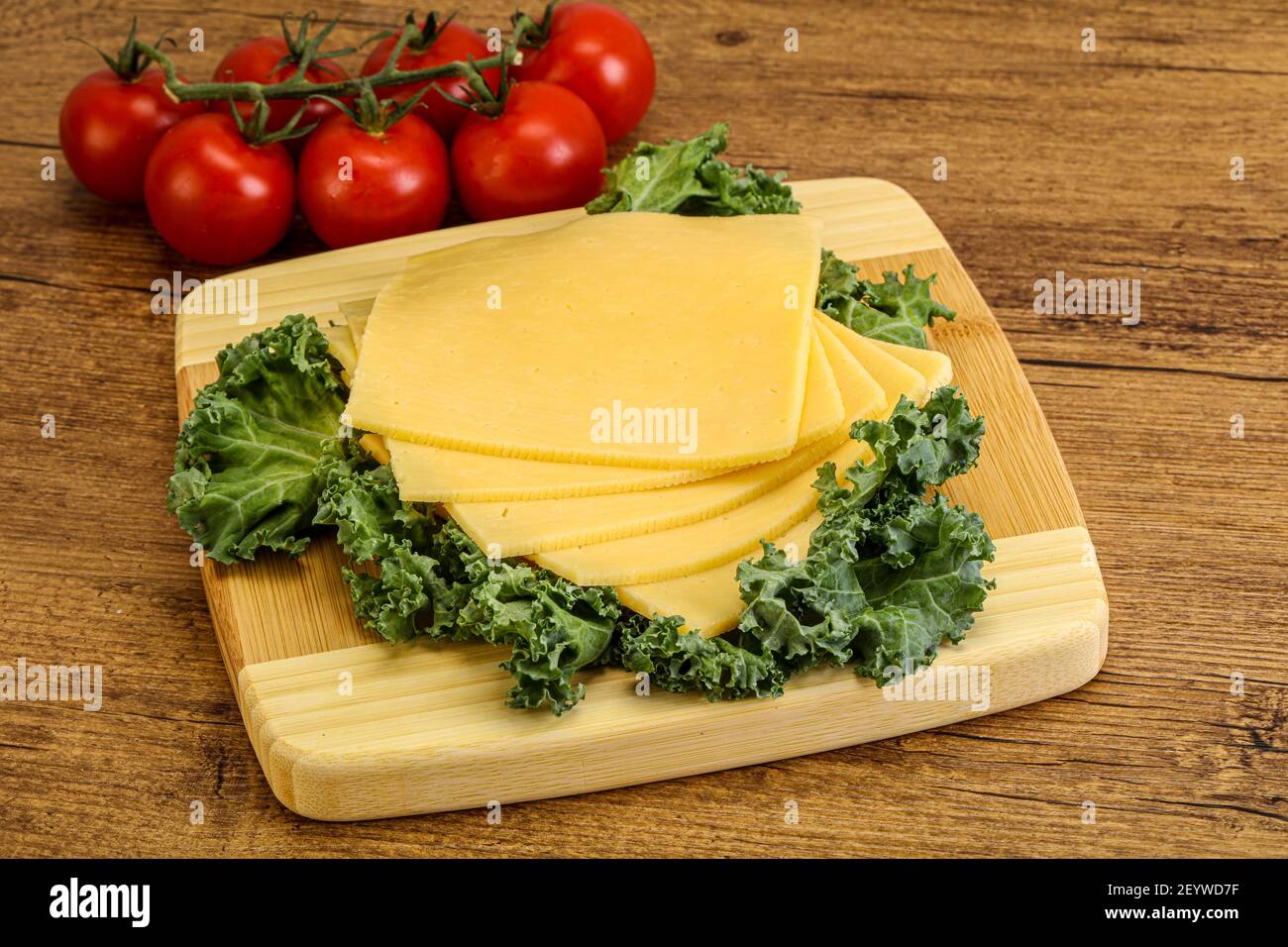 Sliced Gauda cheese snack over board Stock Photo - Alamy