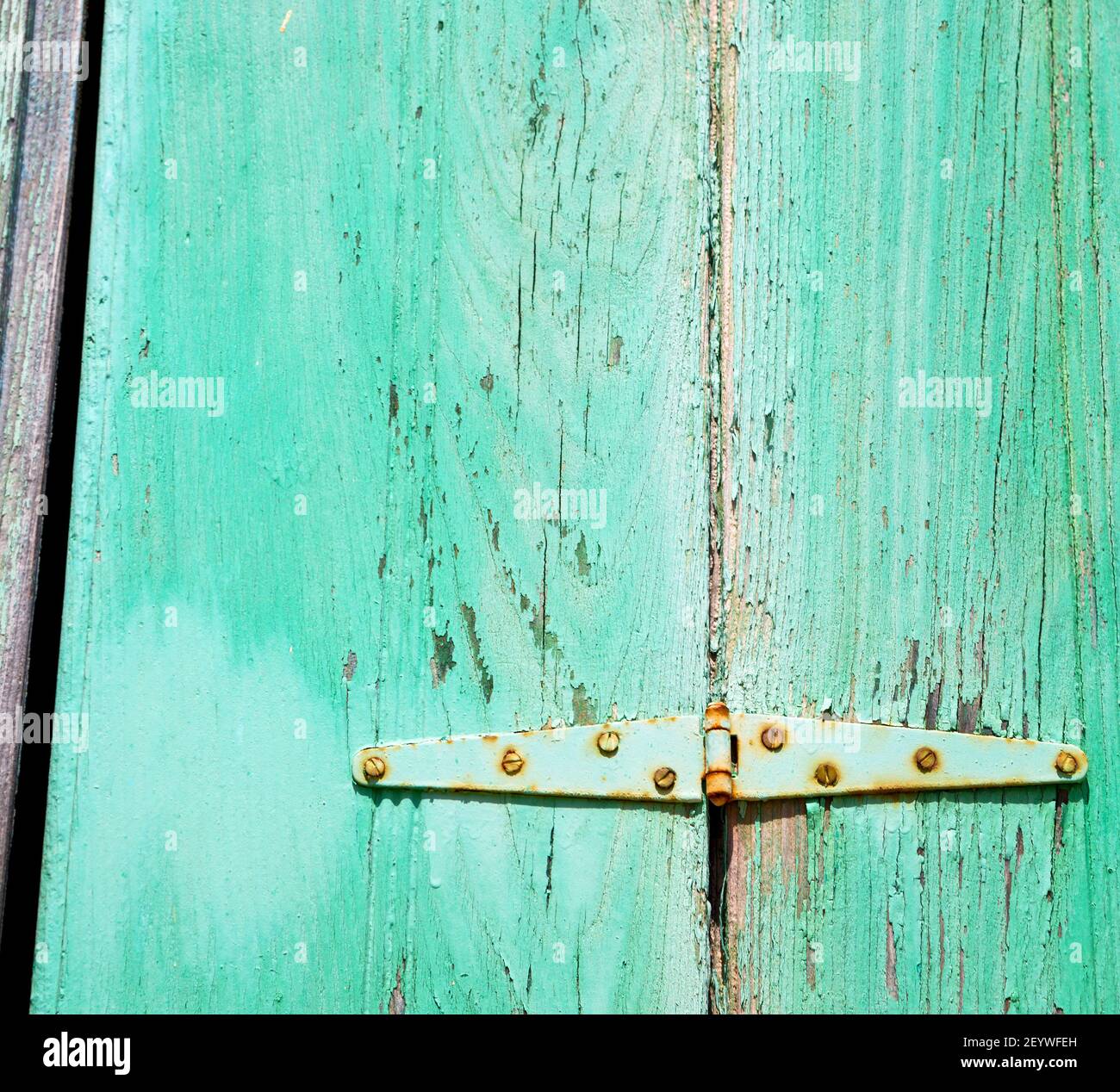 In the old wall a hinged window green wood and rusty metal Stock Photo ...