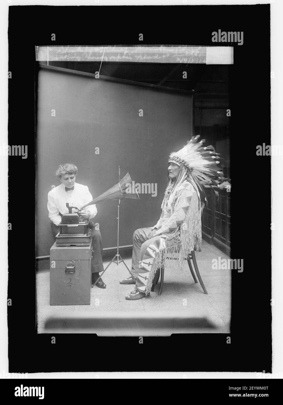Piegan Indian, Mountain Chief, listening to recording with ethnologist ...