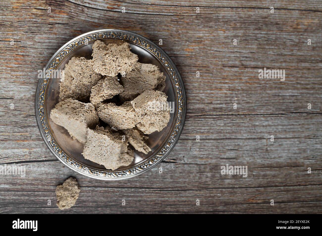 Vegetable-based halva sweet prepared from seeds on wooden background ...