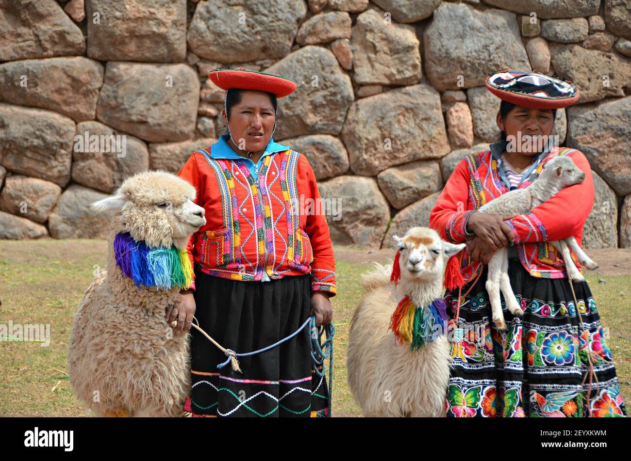 Native Quechua women with colorful outfits and their alpacas at ...