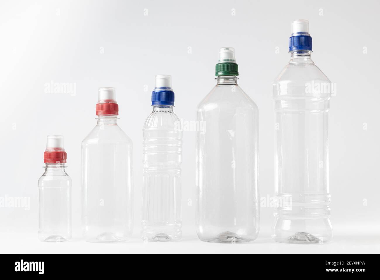 A closeup of empty plastic bottles of various sizes isolated on a white ...