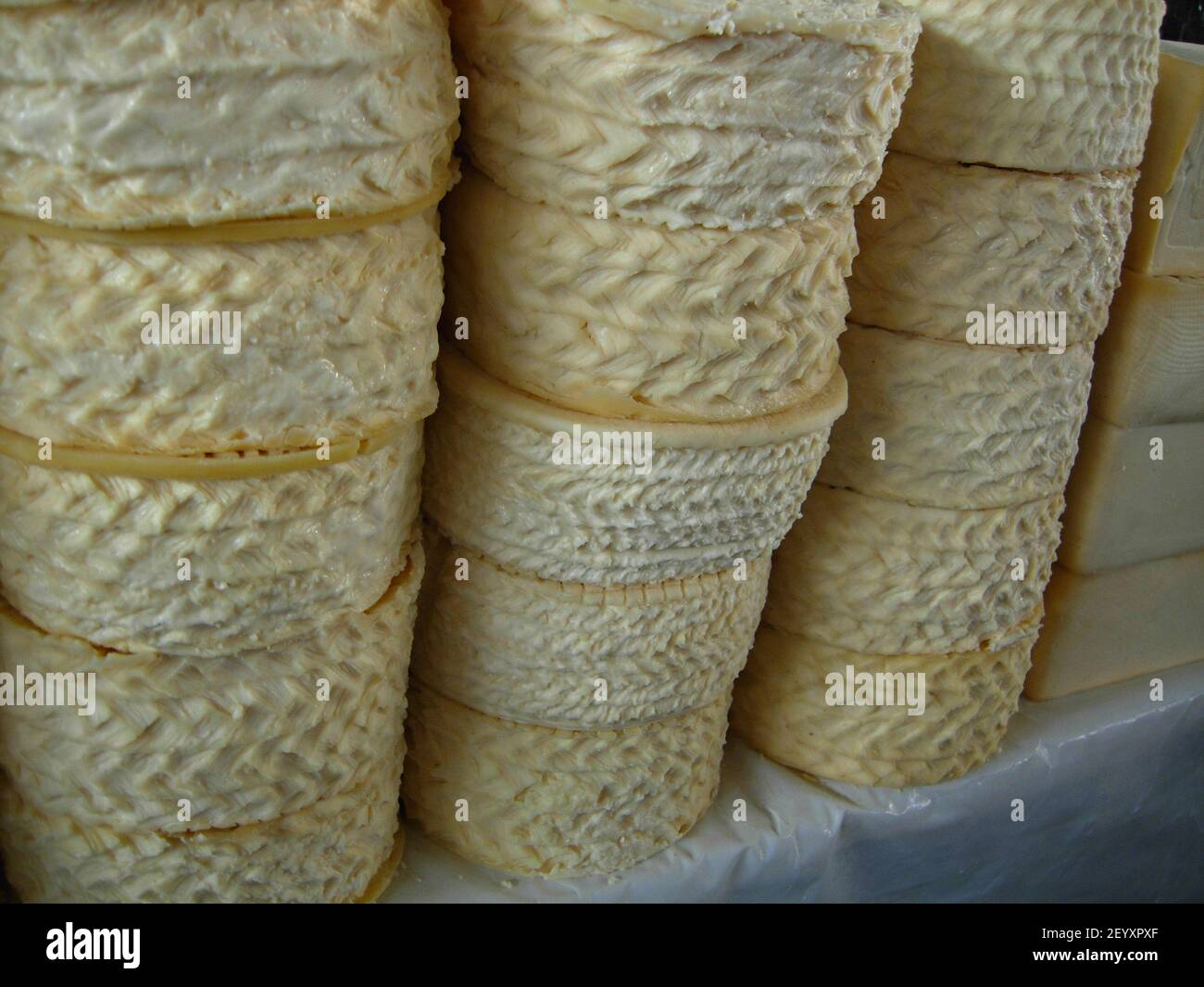 Rounds of homemade artisan Peruvian cheese as seen at the local Market ...