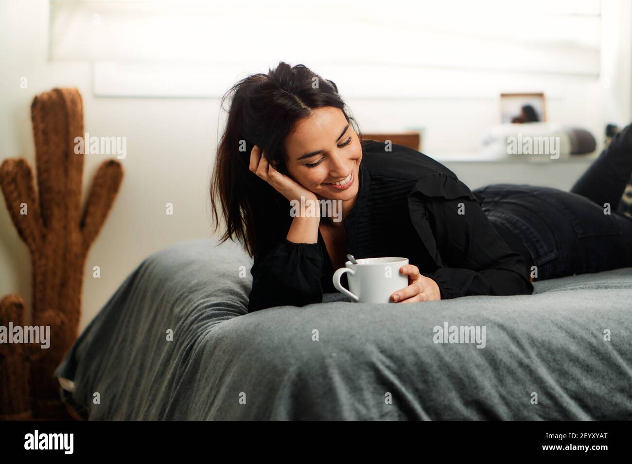 Latin woman laying in bed hi-res stock photography and images - Alamy