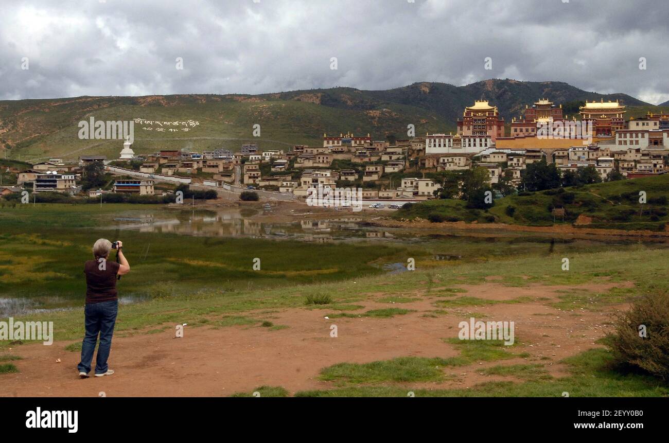 TOURIST PHOTOGRAPHS THE SONGZHANLIN MONASTERY, ZHONGDIAN, YUNNAN ...