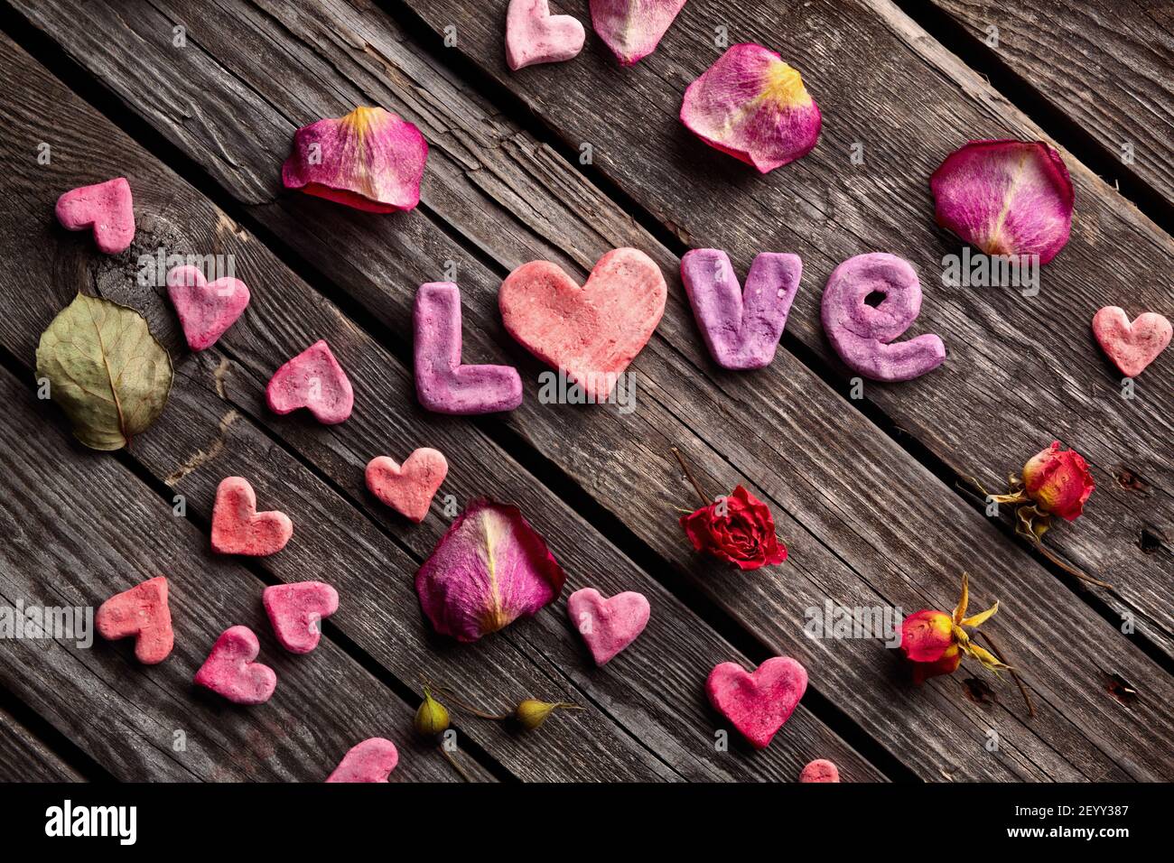 Word Love with rose petals and small heart Stock Photo - Alamy