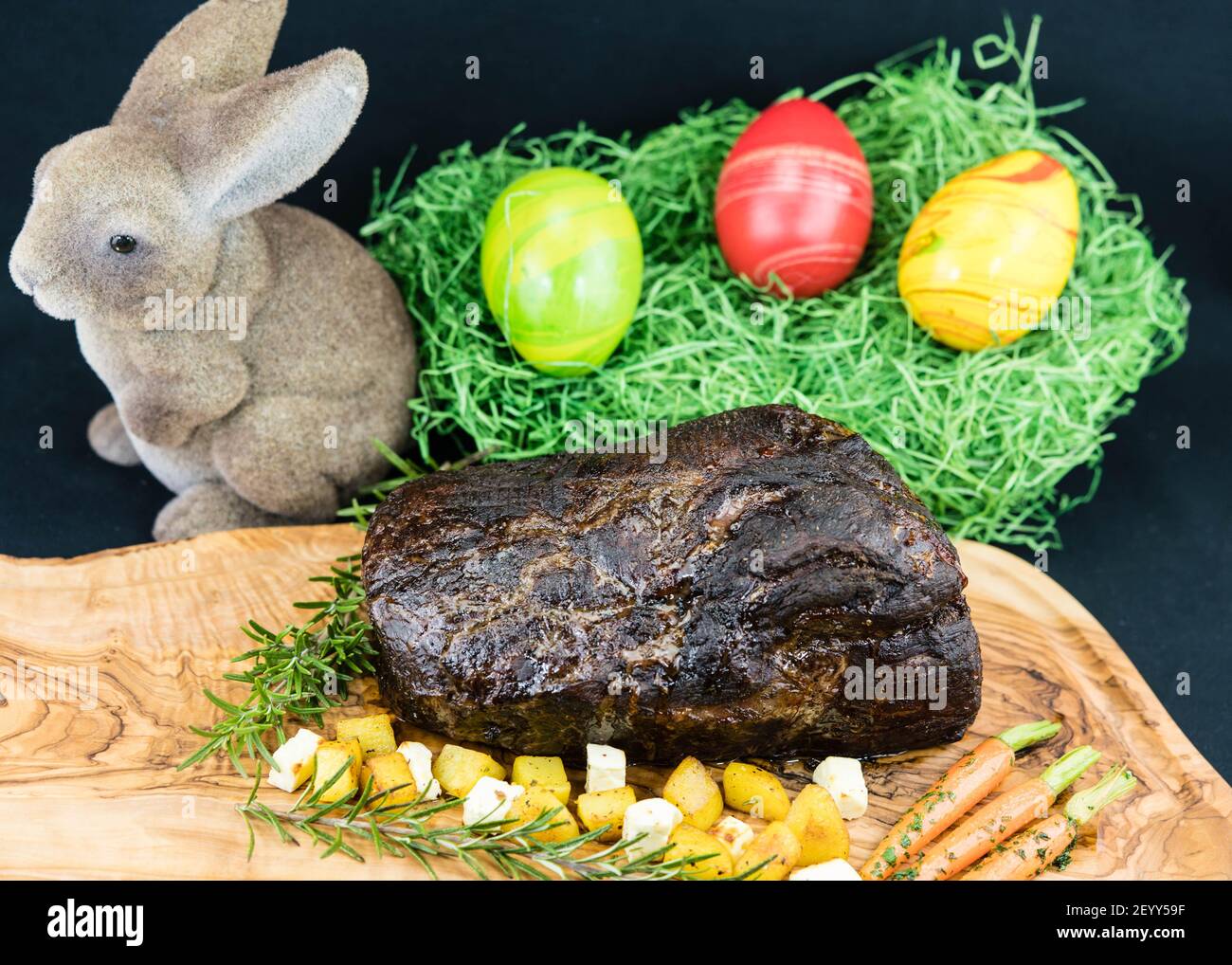 Easter roast beef shoulder with rosemary potatoes Stock Photo - Alamy