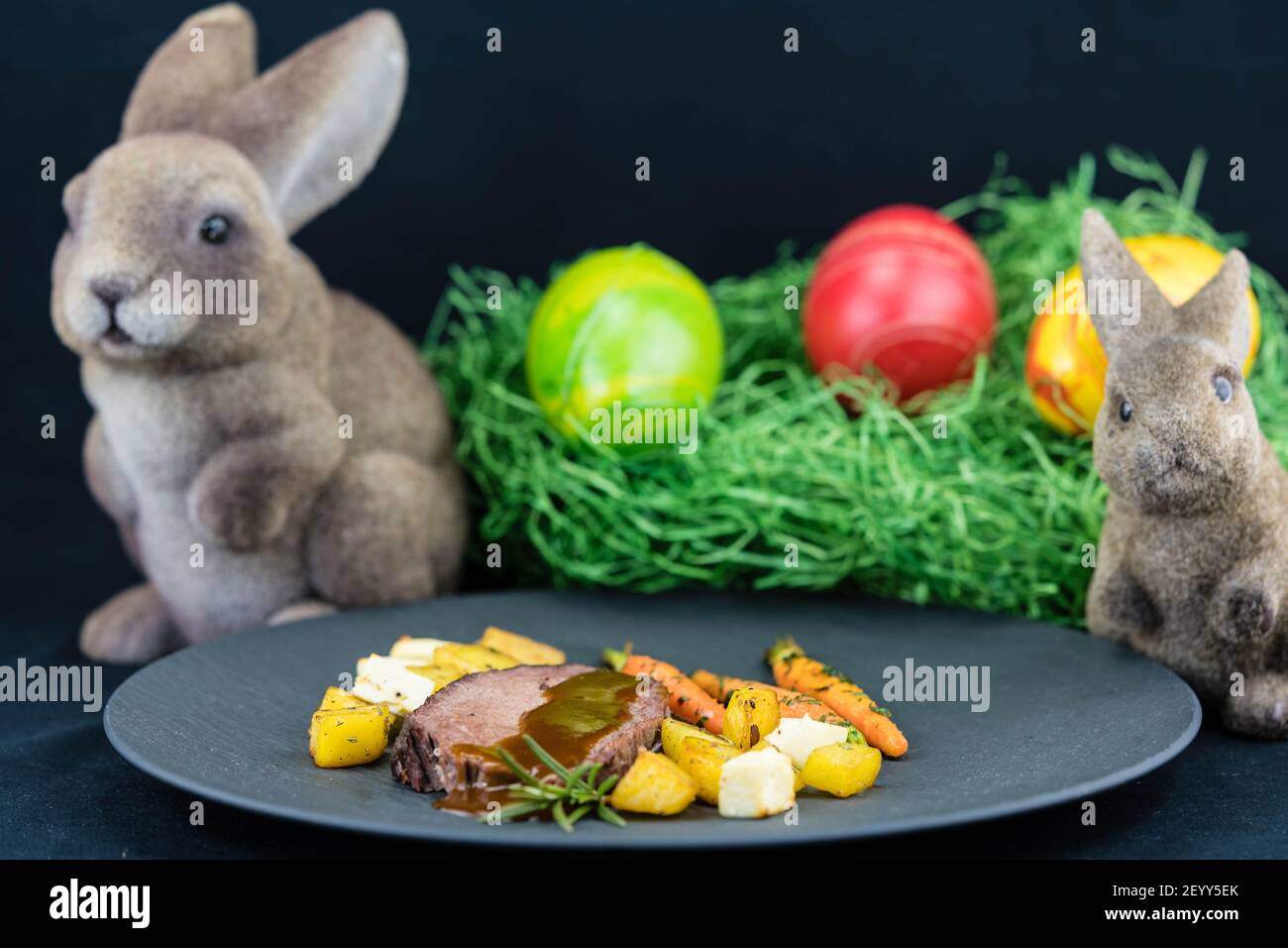 Easter roast beef shoulder with rosemary potatoes Stock Photo - Alamy