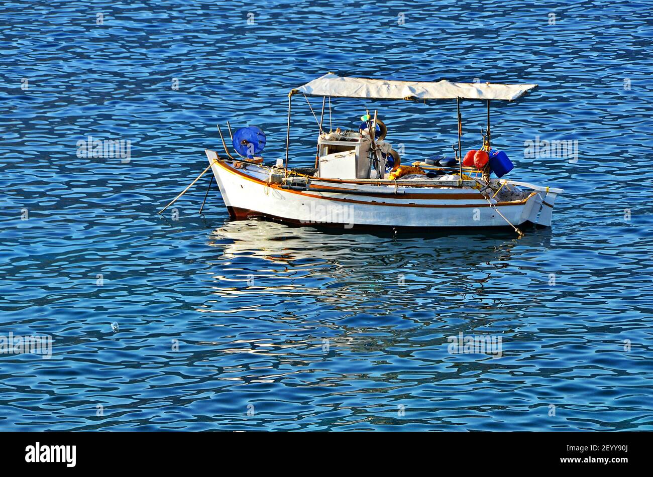 Traditional Greek fishing boat on the waters of Limeni, a coastal ...