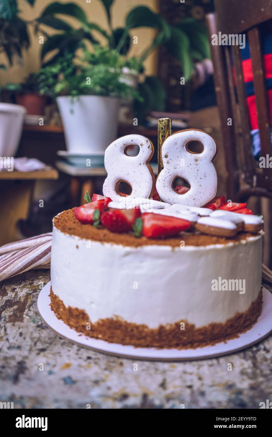 side view of homemade birthday cake with 88 edible numbers on it and ...