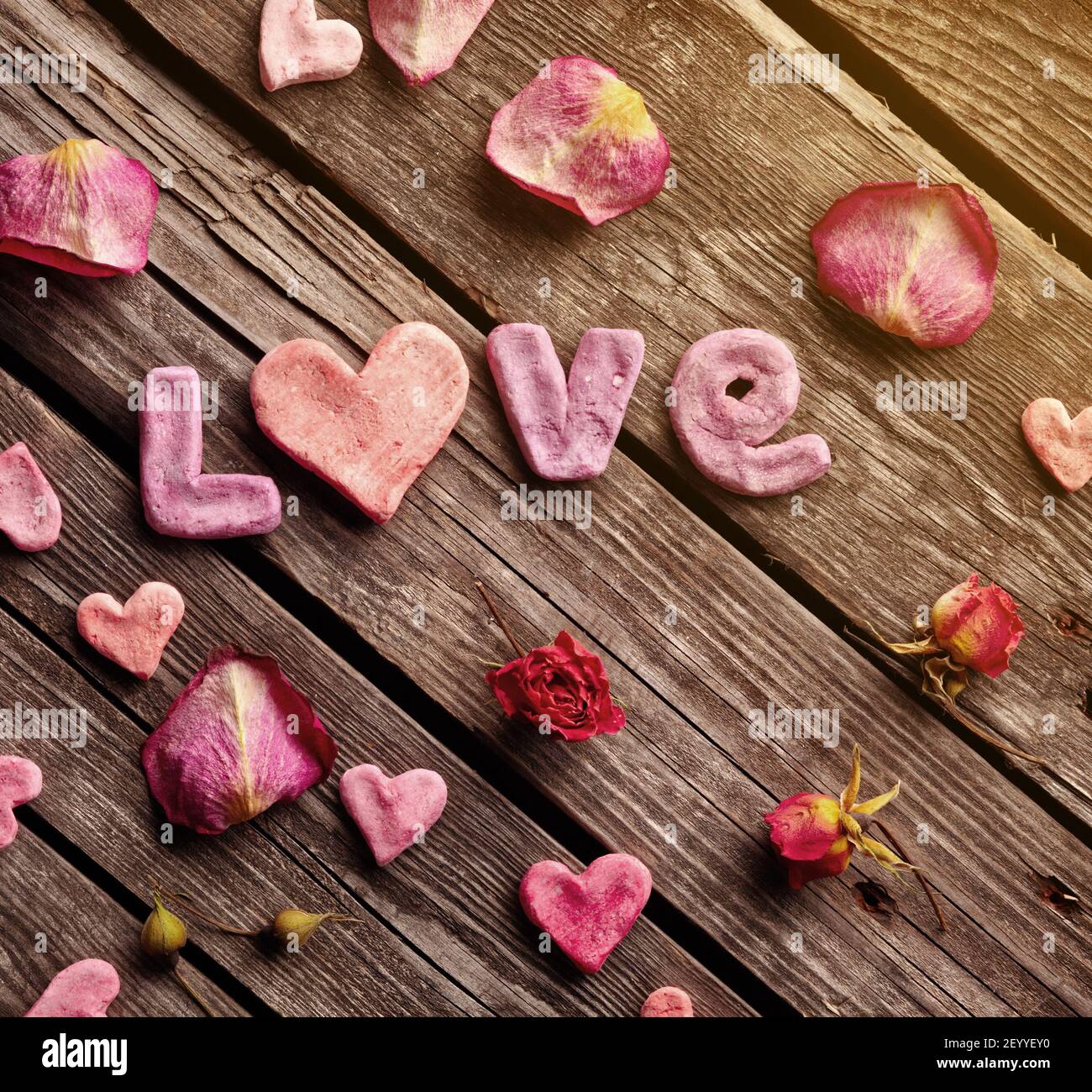Word Love with rose petals and small heart Stock Photo - Alamy