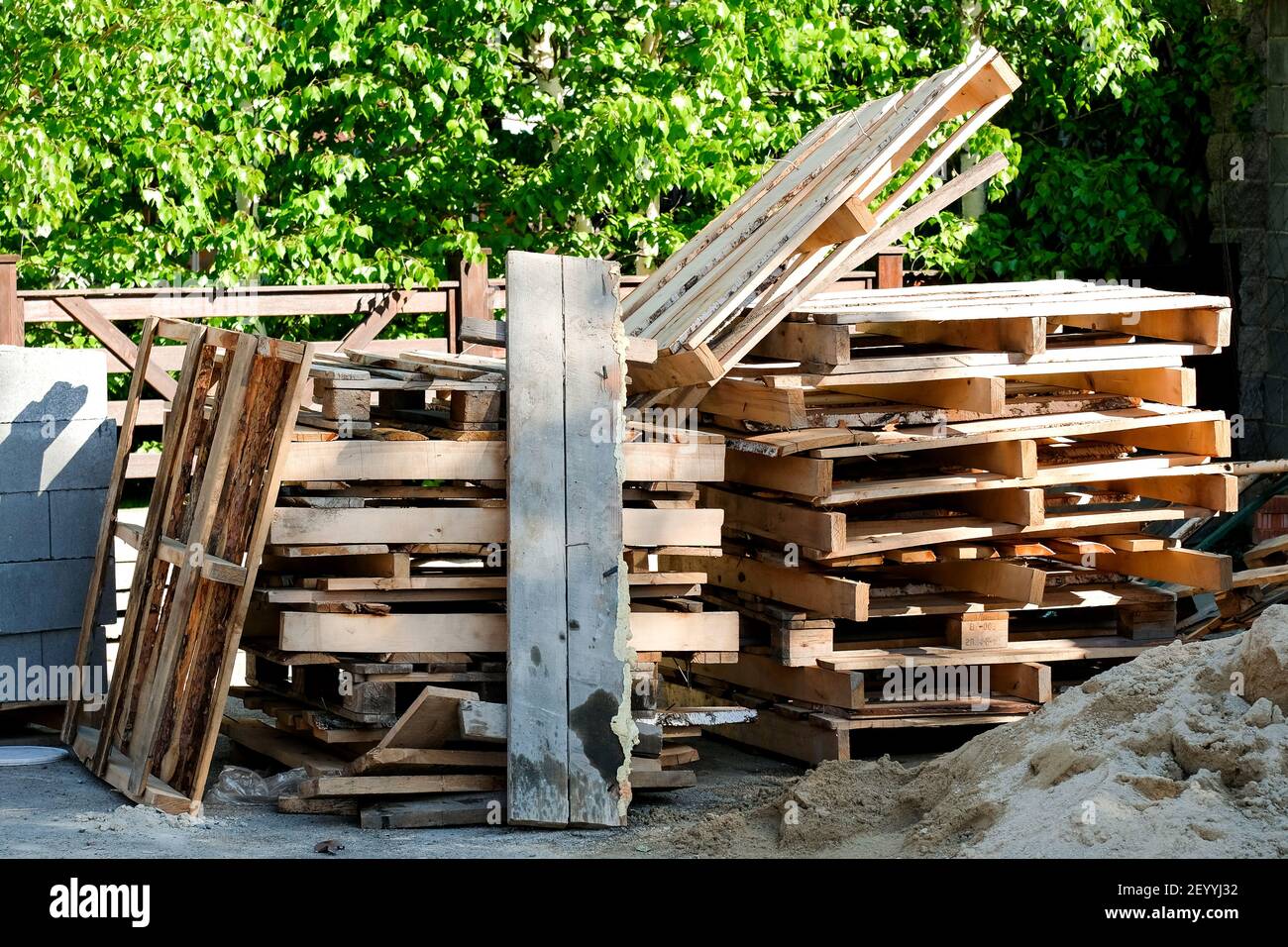 Wooden pallets from transportation. Garbage on the street in summer ...