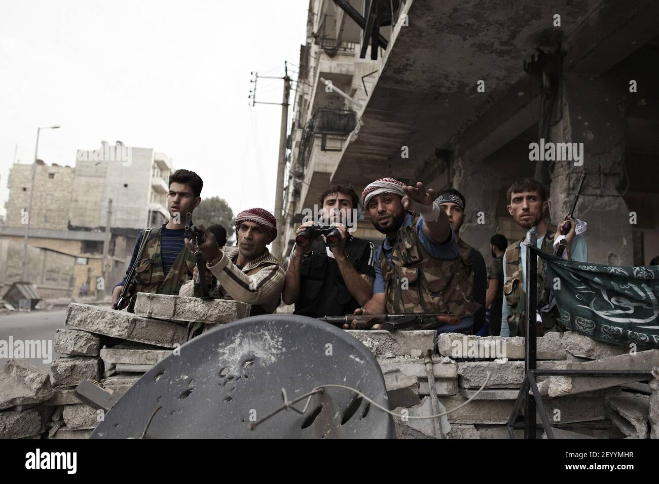 21 October 2012 - Aleppo, Syria -FSA fighters along one of Aleppo's ...