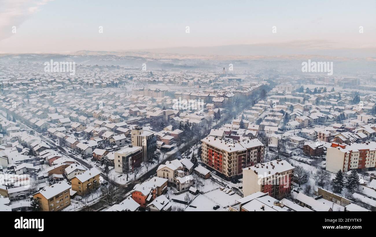 An aerial shot of the streets and buildings in a small town covered in ...