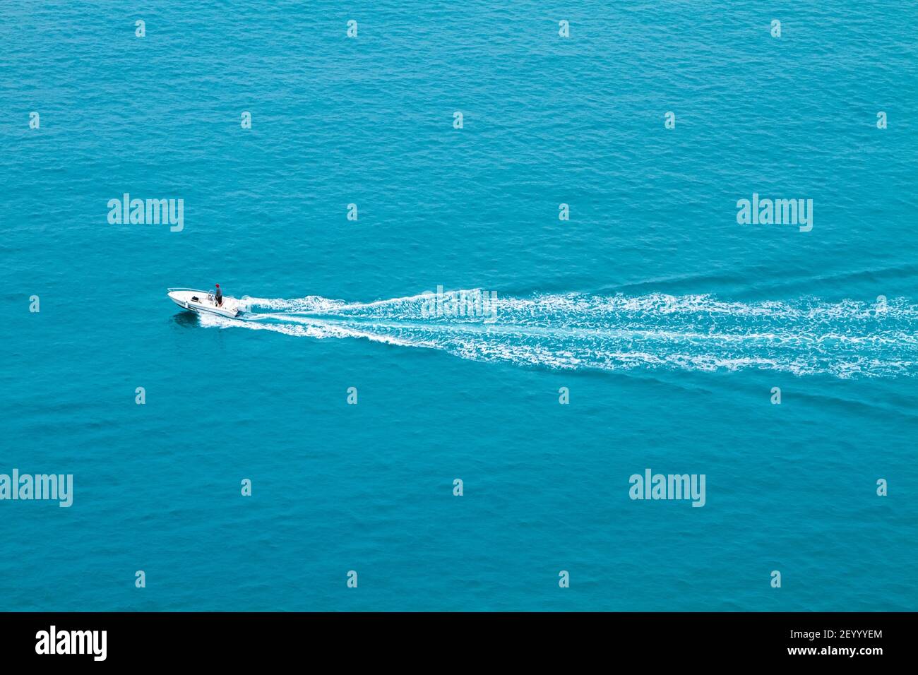 Speed boat quickly floating on the water surface and leaving a trail on ...