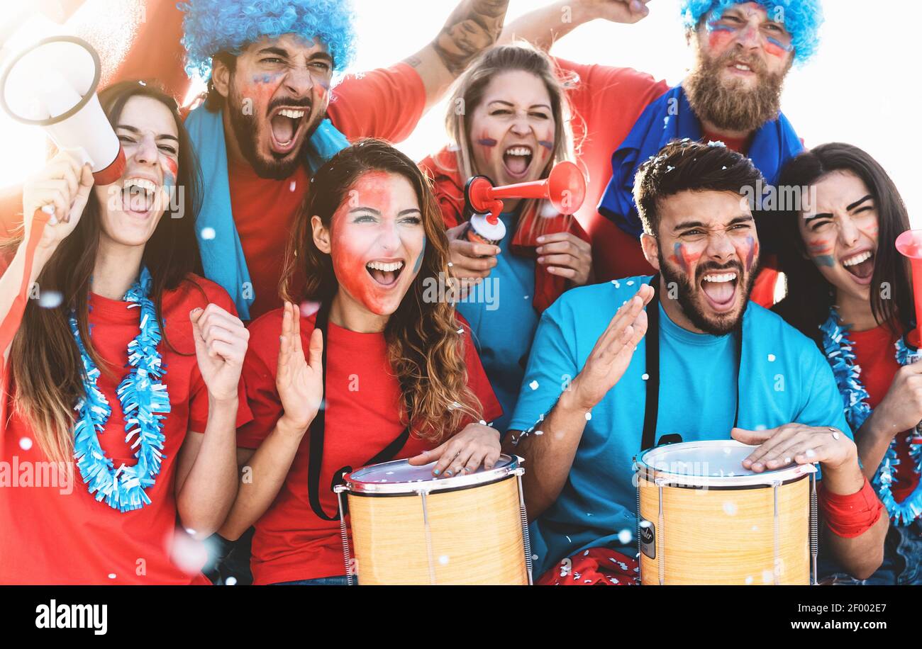 Football fans watching soccer match event at stadium - Young people ...