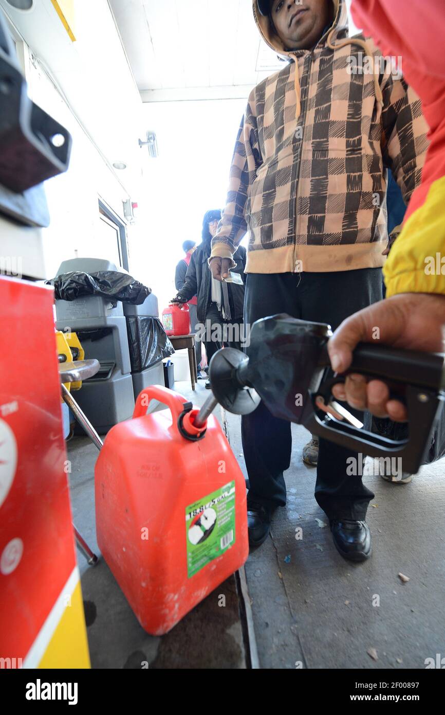03 NOVEMBER 2012 - New York - A man watched over a gas attendant fill ...