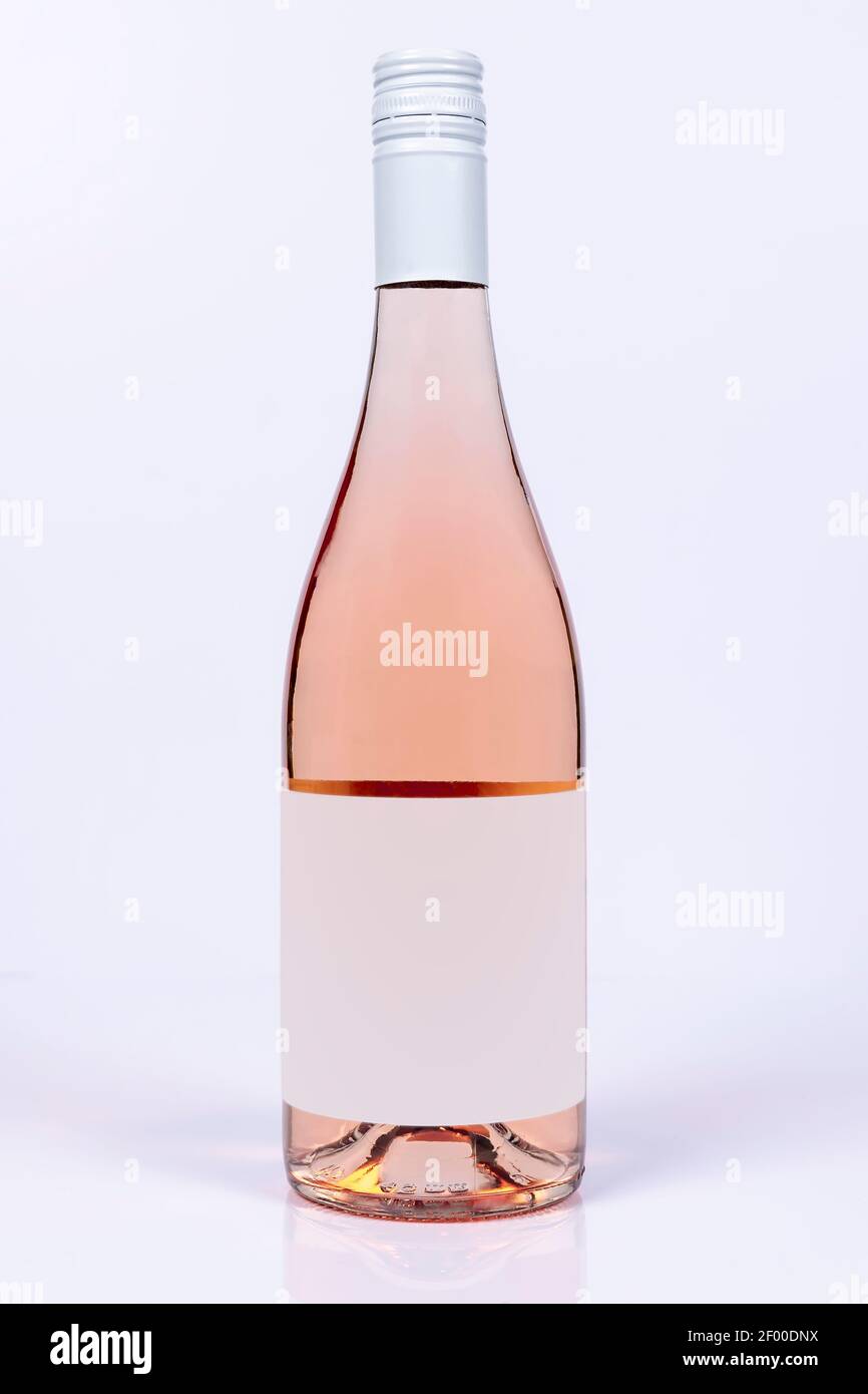 Beautiful burgundy bottle of rose wine on white surface and background ...
