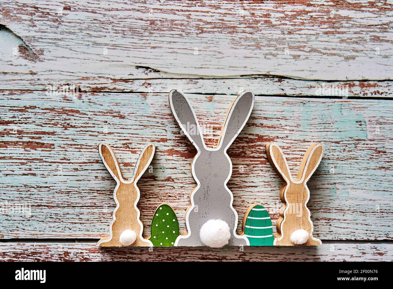 Three wooden Easter bunnies from behind with decoration Stock Photo - Alamy