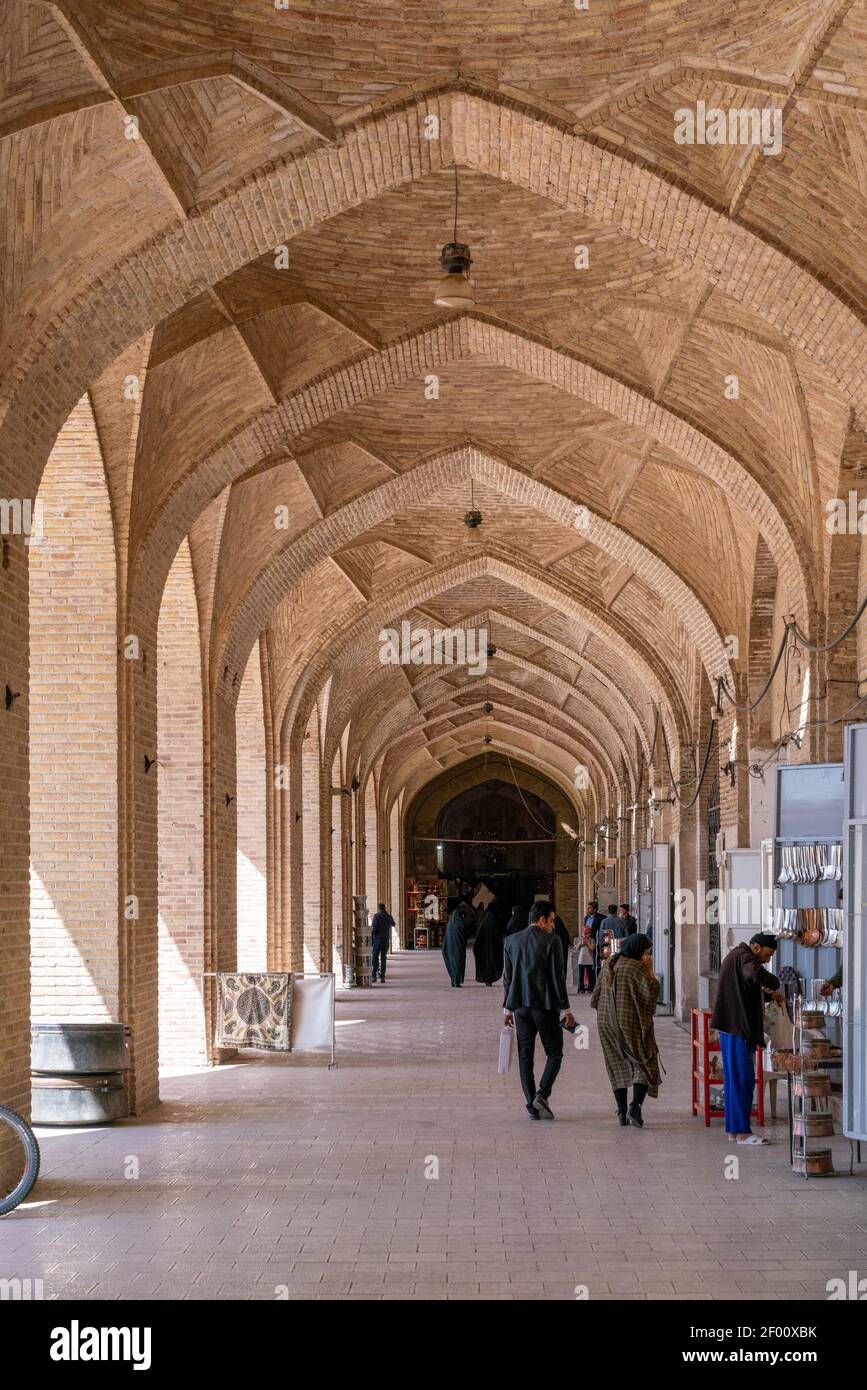 Kerman, Iran - 19.04.2019: People walking around and sitting in the ...