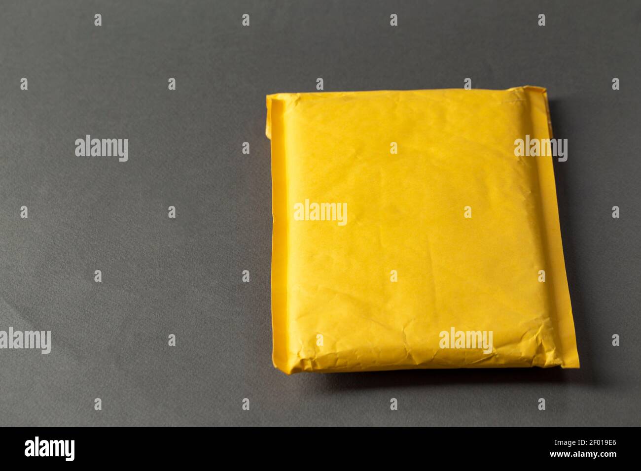 Yellow paper bag on a gray background. Packaging for international ...