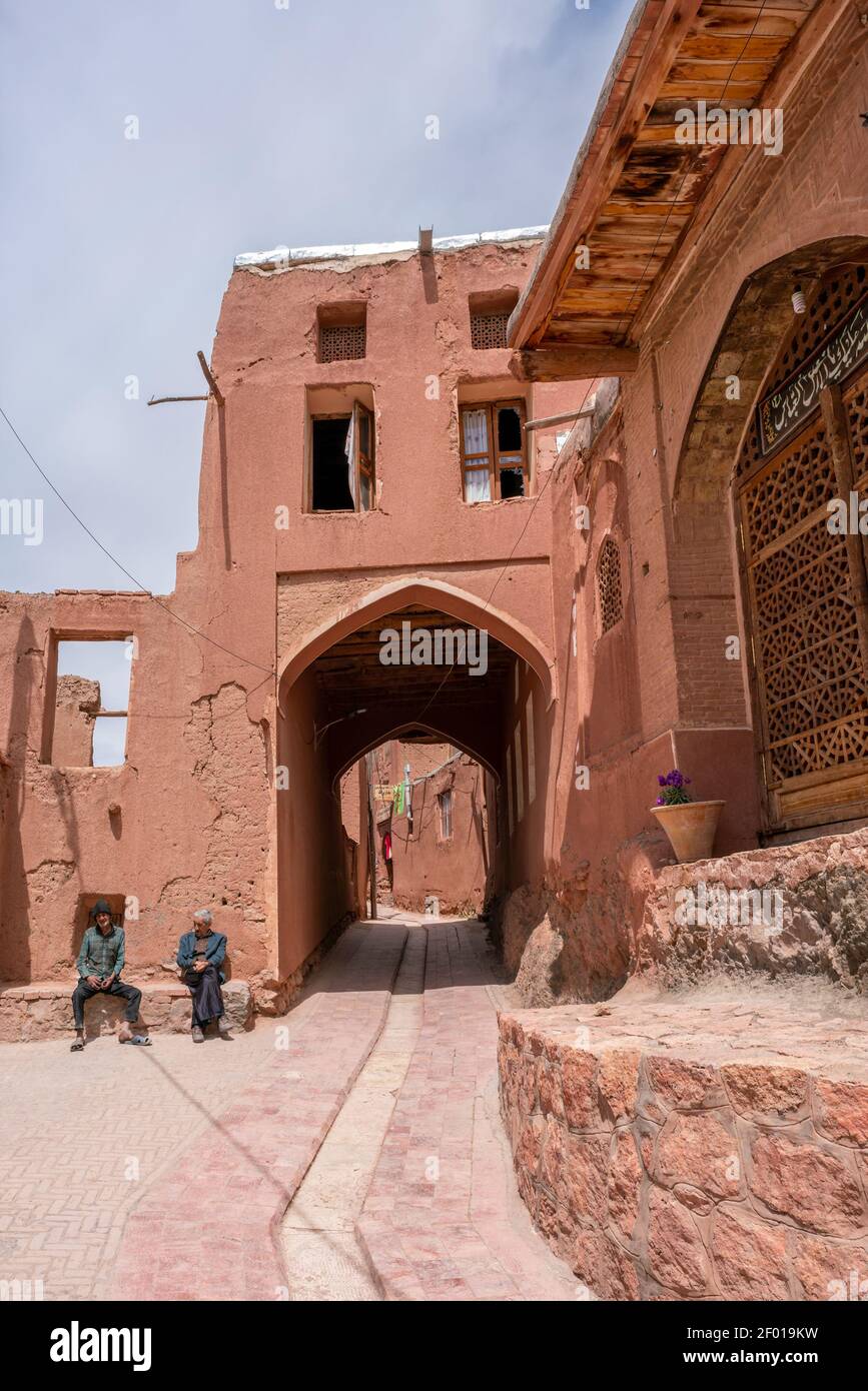 Abyaneh, Iran - 18.04.2019: Men sitting in the street of famous old ...