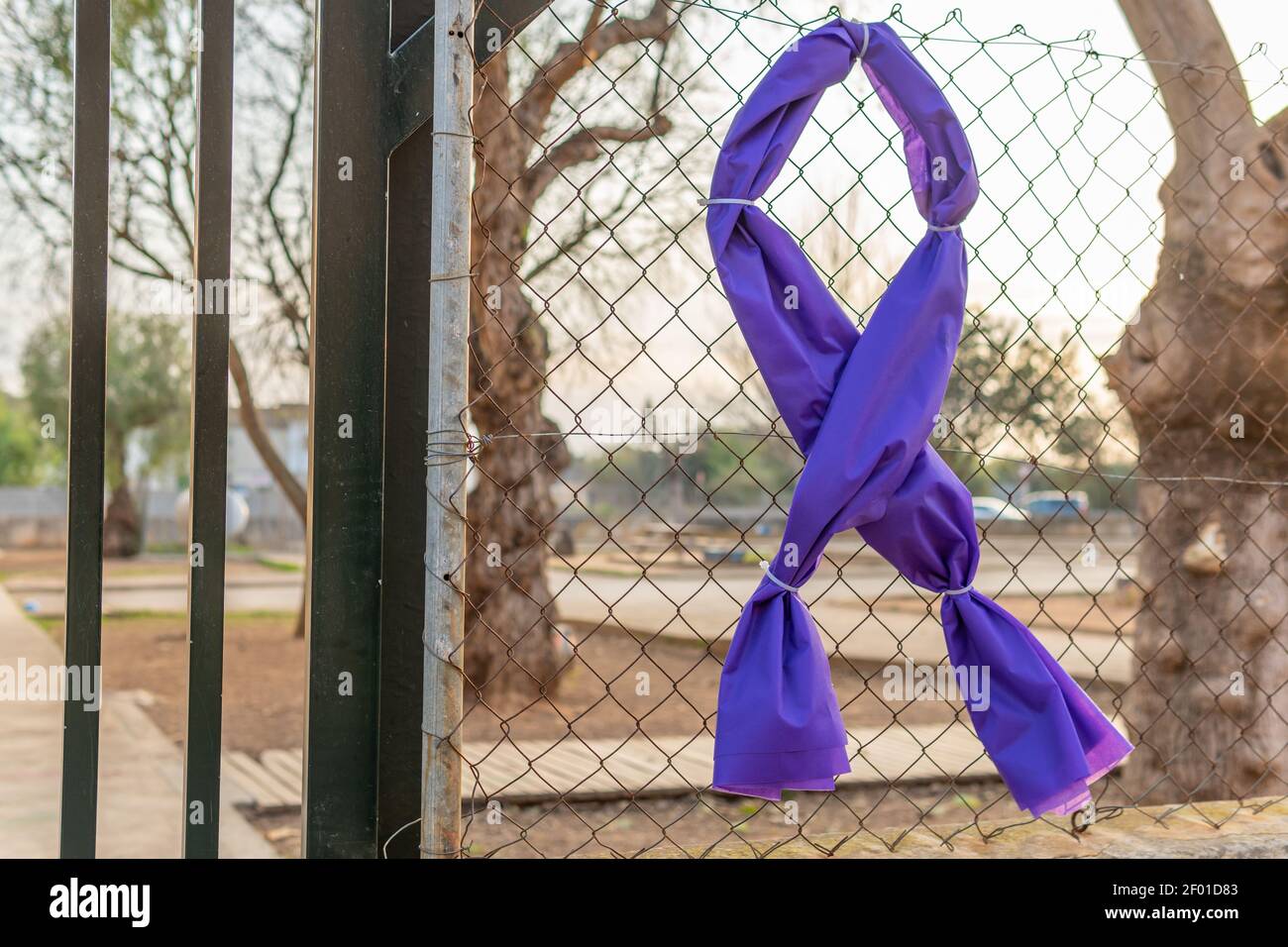 Symbol of a purple ribbon made of fabric and tied with flanges to a ...