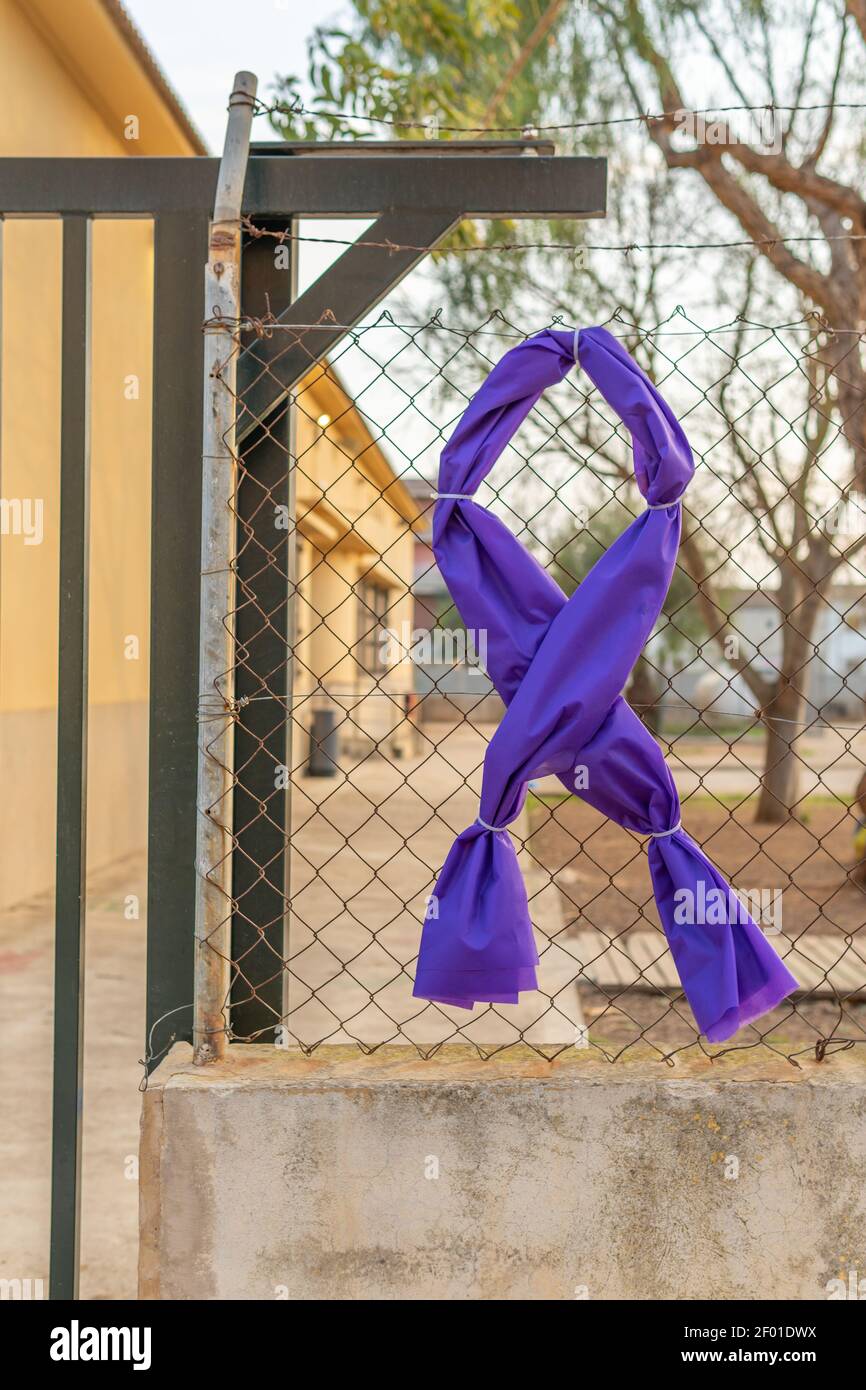Symbol of a purple ribbon made of fabric and tied with flanges to a ...