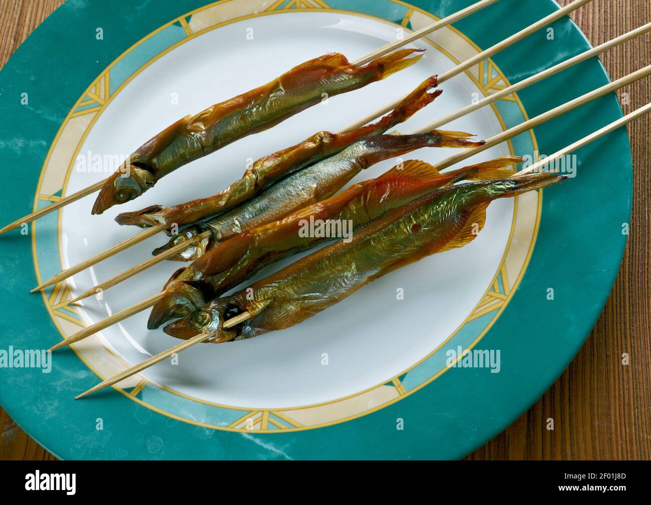 Grilled fish on a stick Stock Photo - Alamy