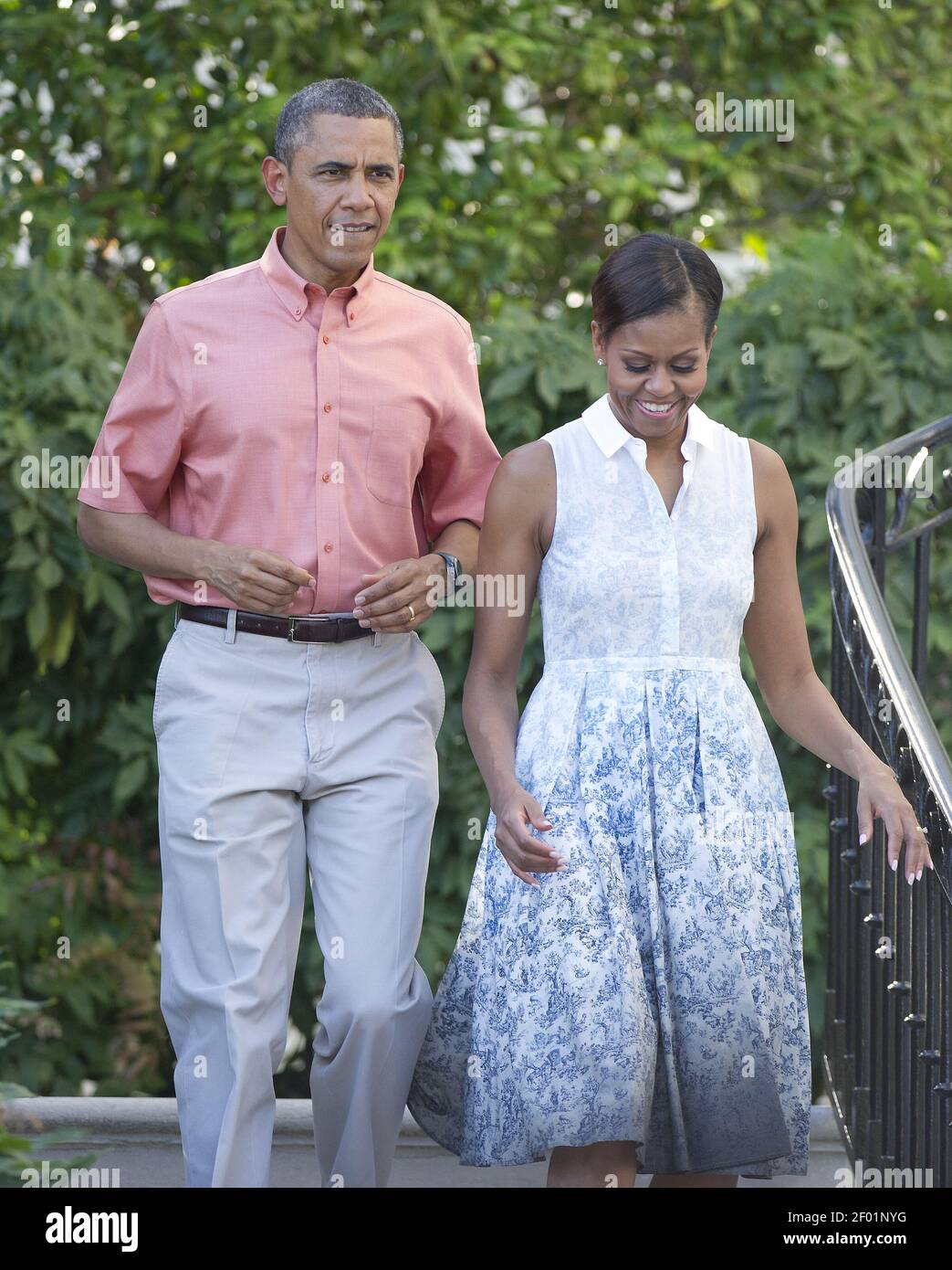United States President Barack Obama and first lady Michelle Obama walk ...