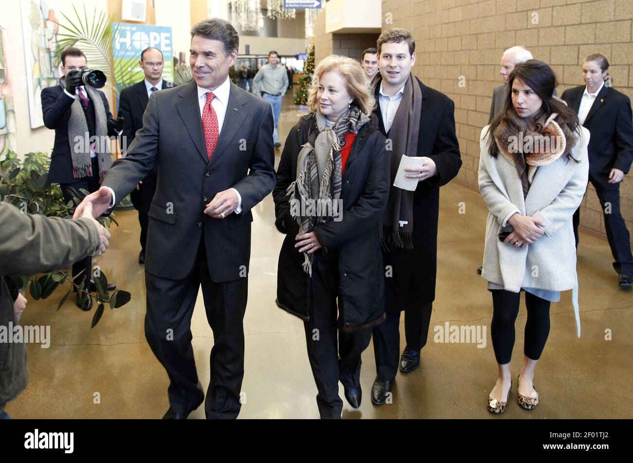 Texas Governor Rick Perry greets churchgoers with his wife Anita, son ...