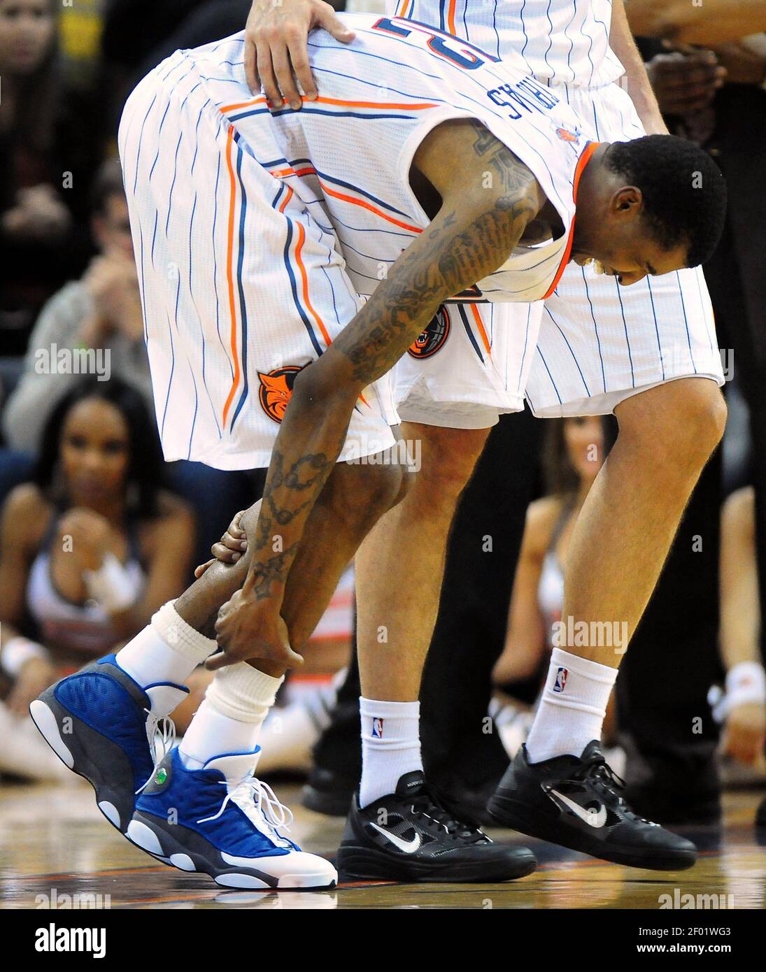 Charlotte Bobcats forward Tyrus Thomas (12) holds his calves after ...