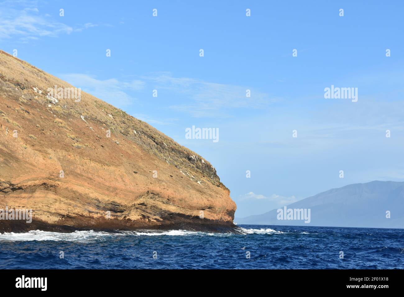 A Molokini Crater rock emerging from the Pacific Ocean near the ...