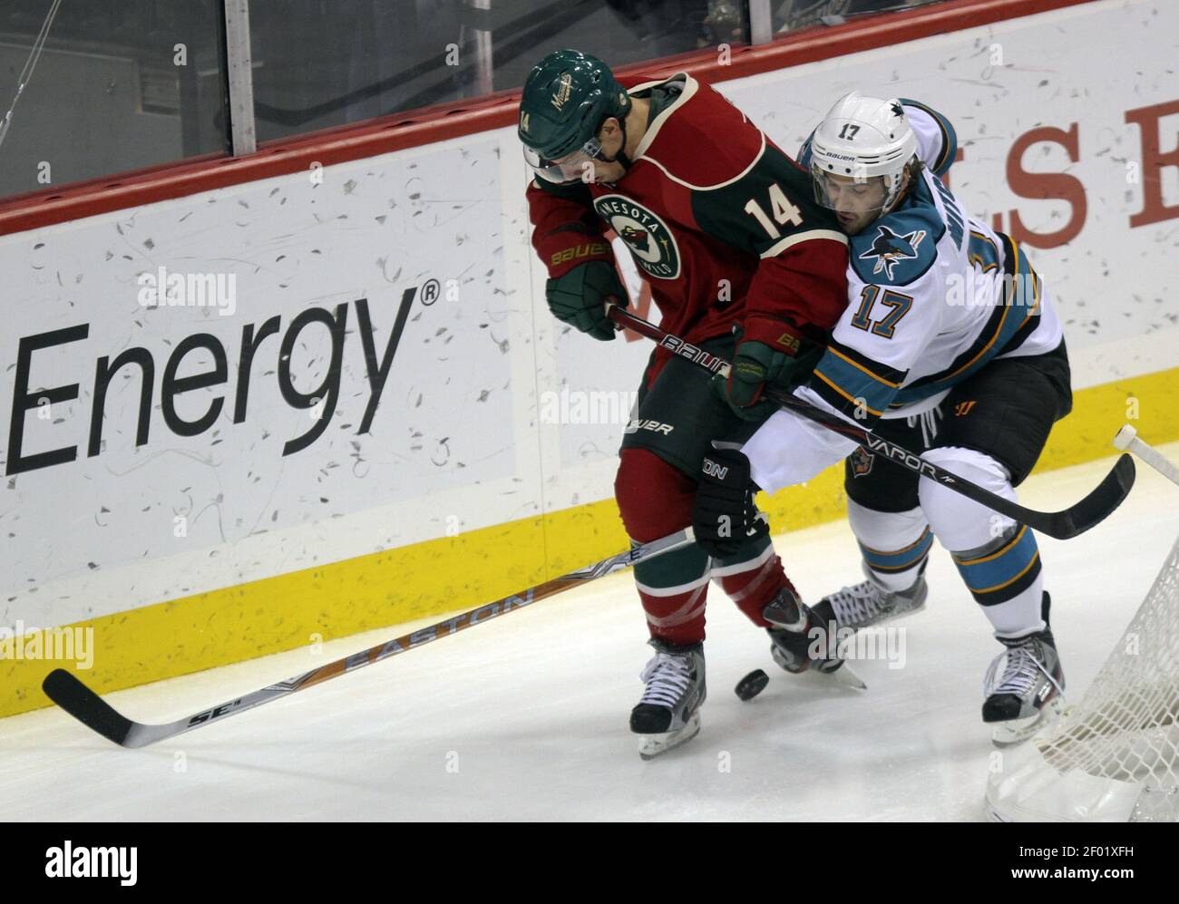 The Minnesota Wild's Darroll Powe (14) tries to kick the puck forward ...