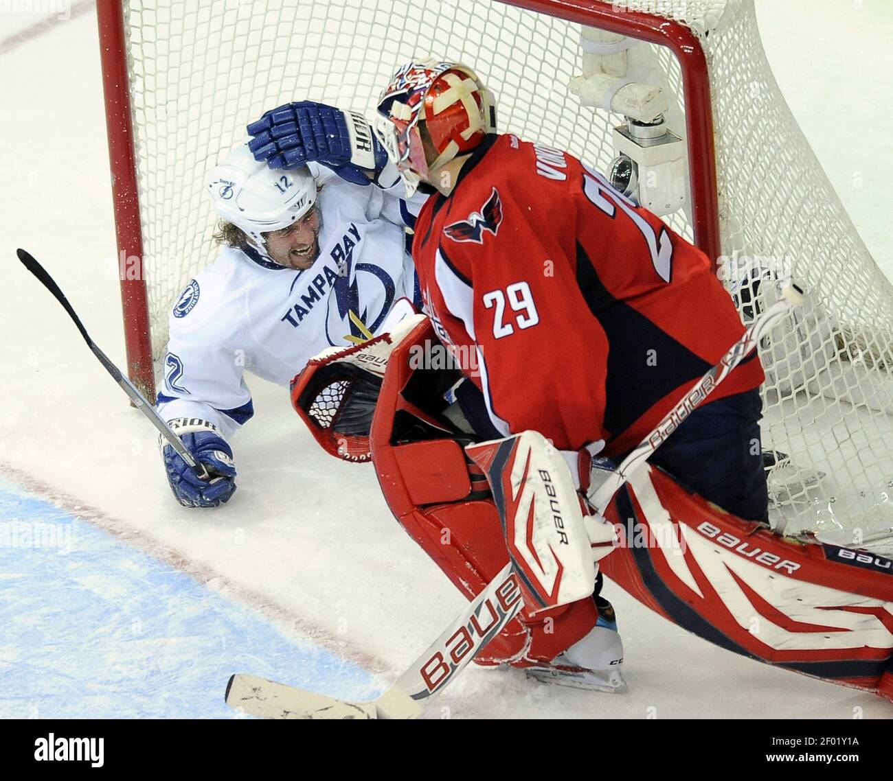Tampa Bay Lightning left wing Ryan Malone (12) holds his head after ...