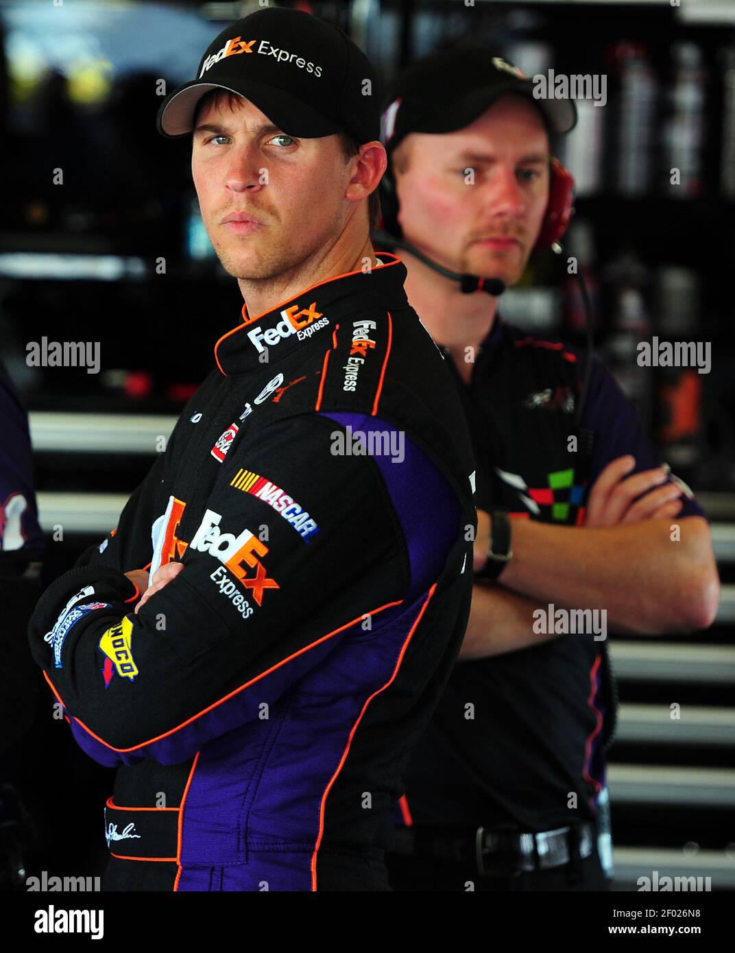 NASCAR Sprint Cup Series driver Denny Hamlin, left, waits with a ...