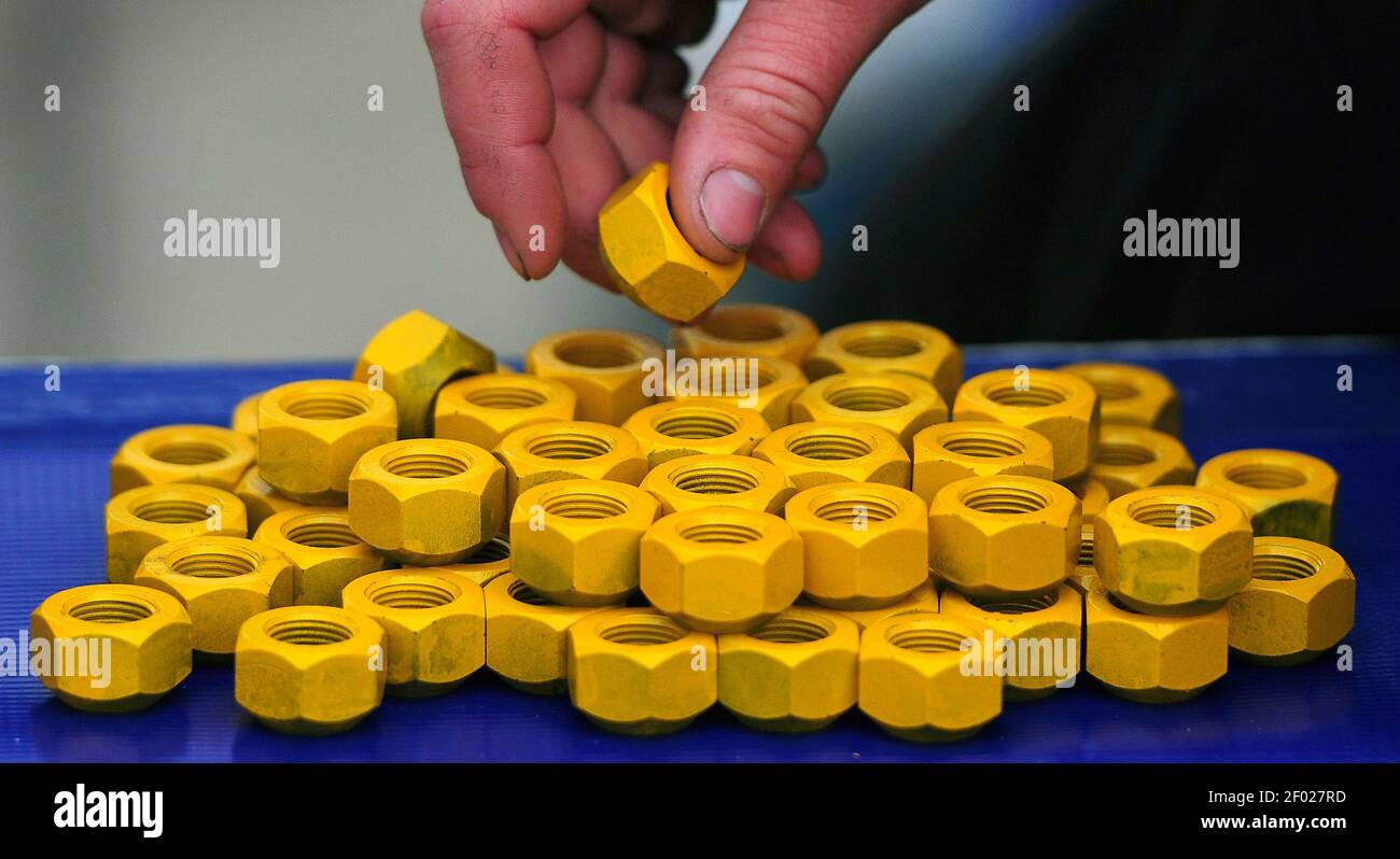A crewman stacks lug nuts along pit road at Daytona International ...
