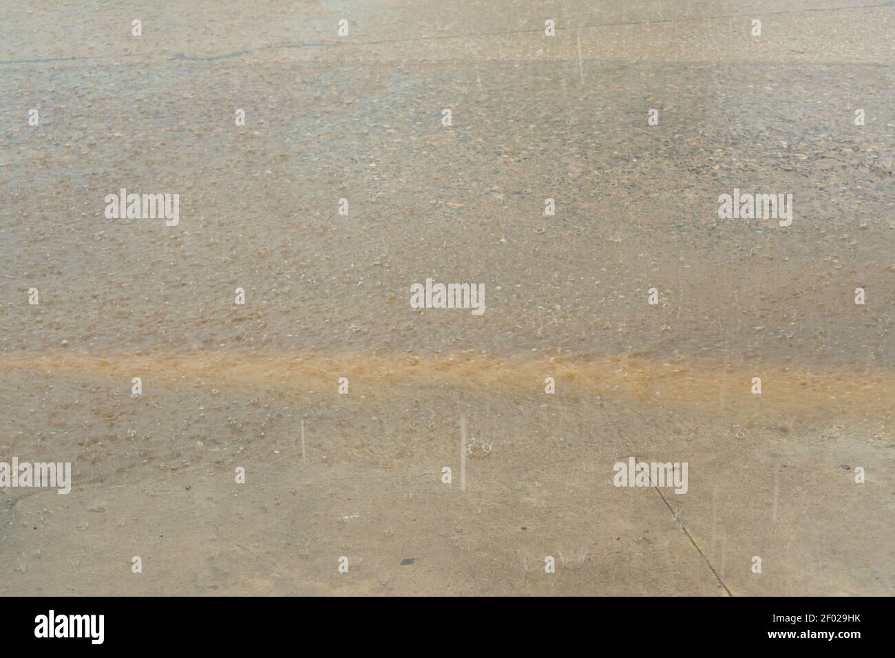 Heavy tropical rain on an island in Thailand. The road is under water ...