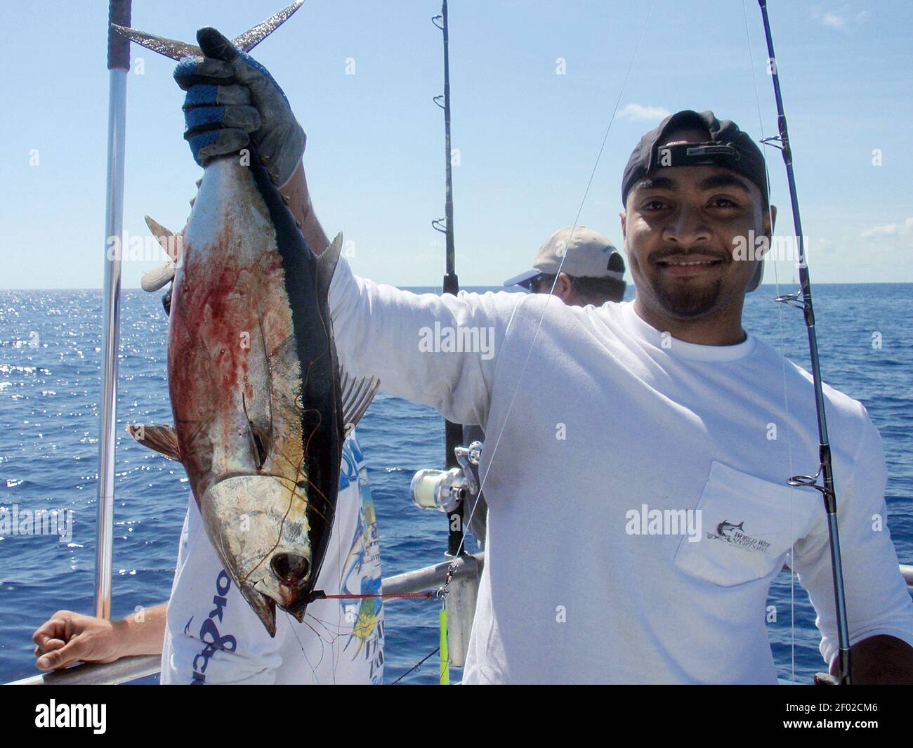 Jomal Whiteside holds up a blackfin tuna he caught on the Reward Won ...