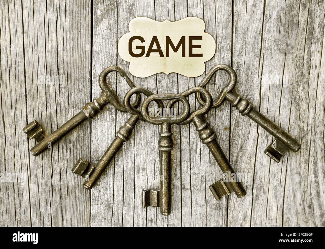 Escape room game concept, old vintage keys on old wooden background ...