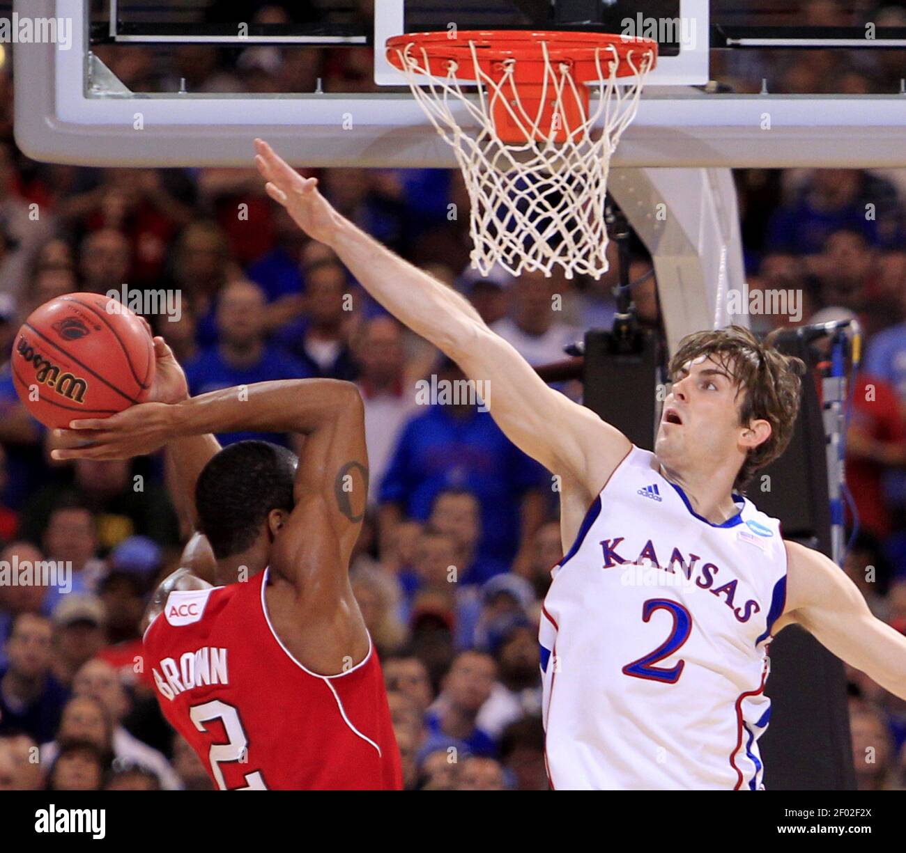 North Carolina State's Lorenzo Brown, left, looks to shoot as Kansas ...