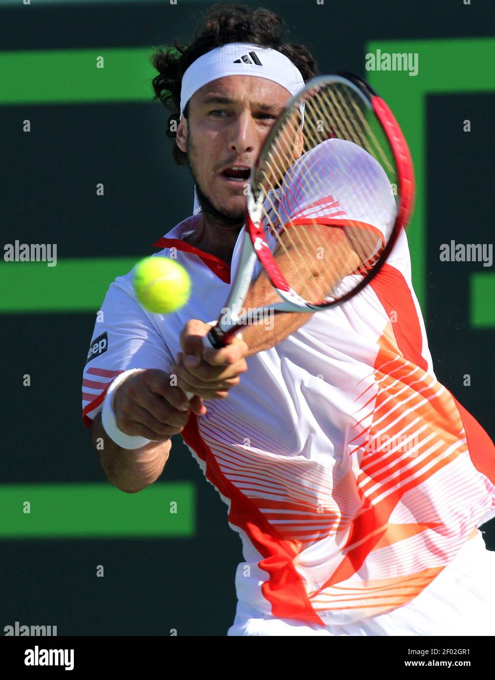 Juan Monaco returns a ball against Mardy Fish during the Sony Ericsson ...
