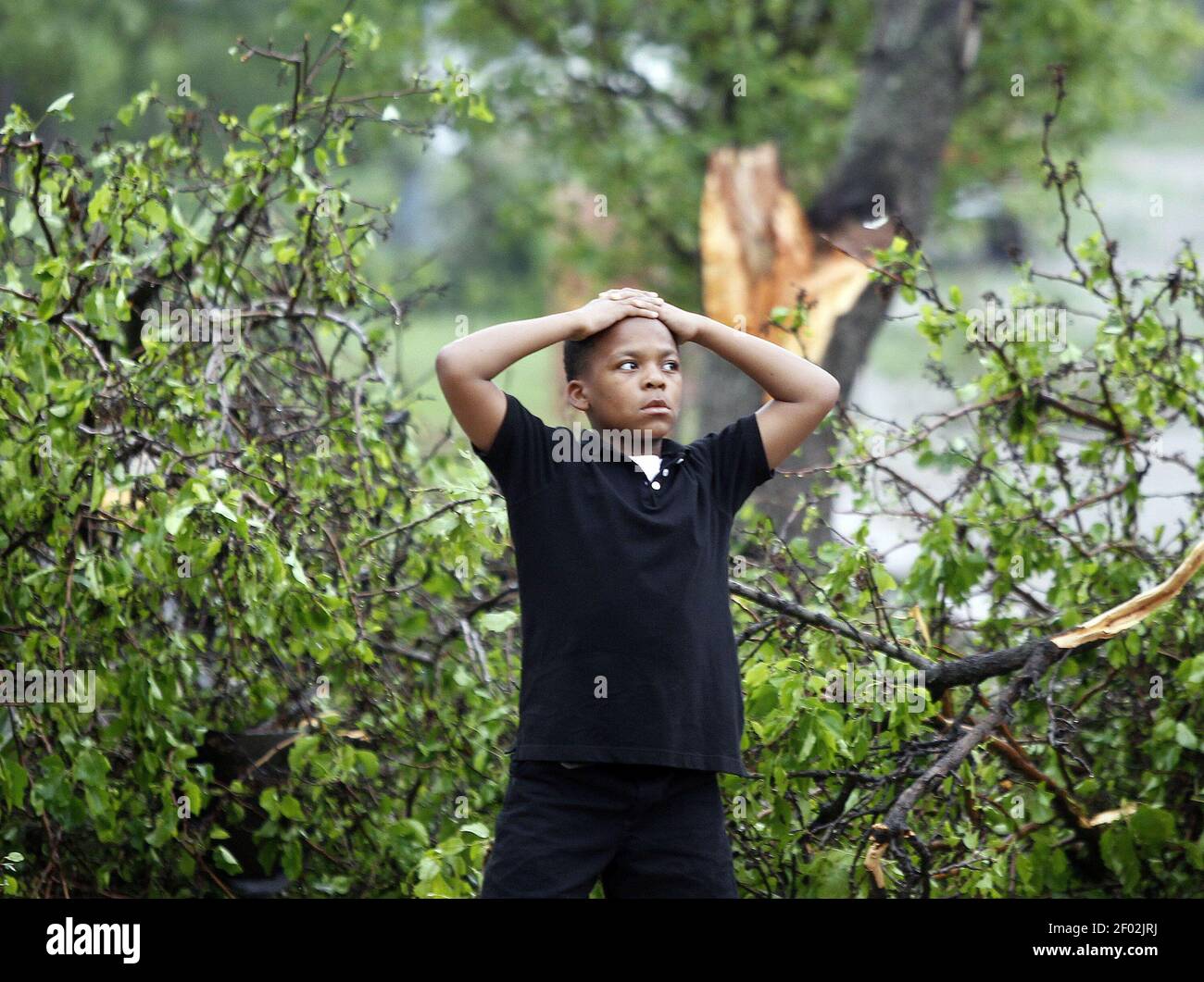 Ten-year-old Ty Proctor surveys damage after a tornado struck Bradley ...