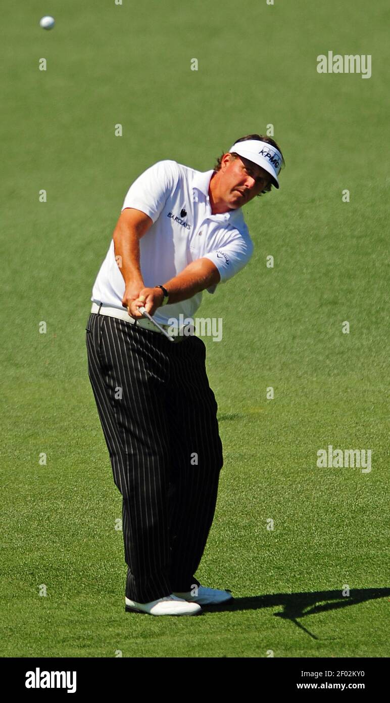 Phil Mickelson chips his ball onto the 2nd green during the third round ...