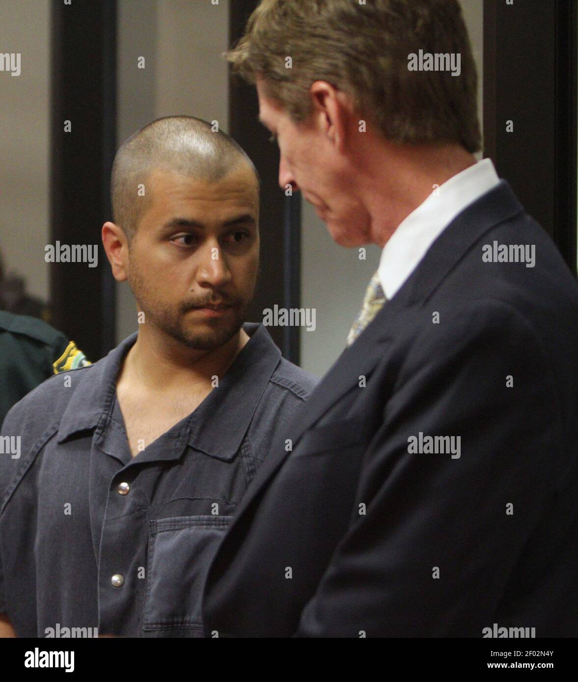 George Zimmerman, left, turns to his attorney Mark O'Mara while ...
