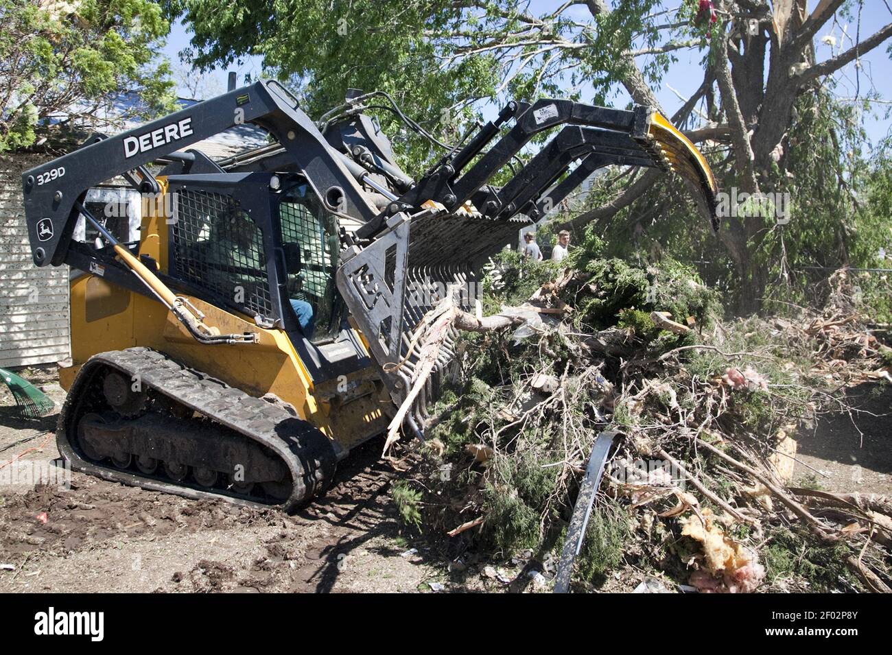 Volunteers with Christian Disaster Relief, Inc. clean debris from an ...