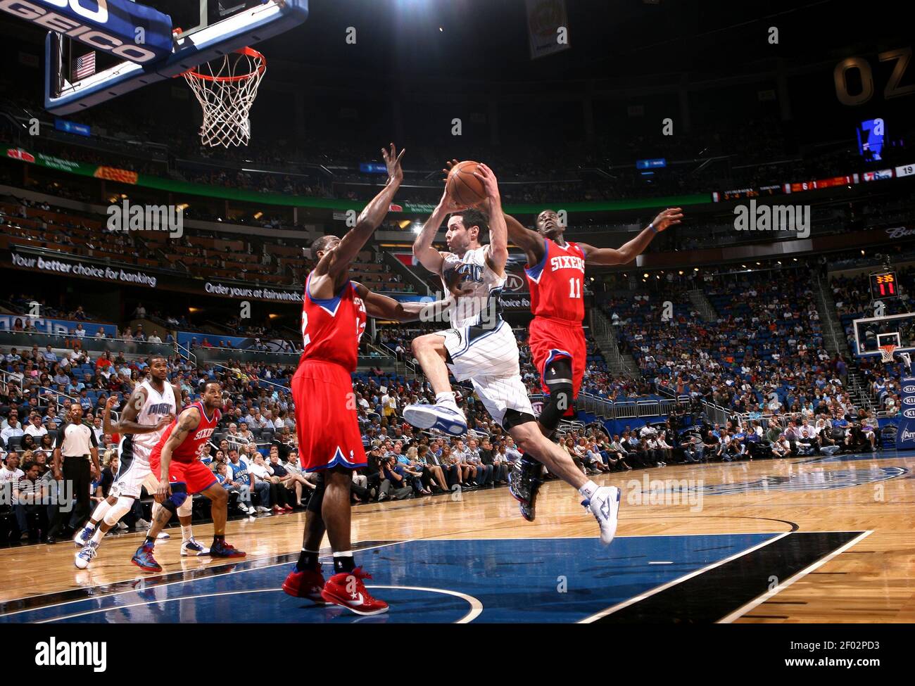 Orlando Magic guard J.J. Redick drives to the basket between two ...