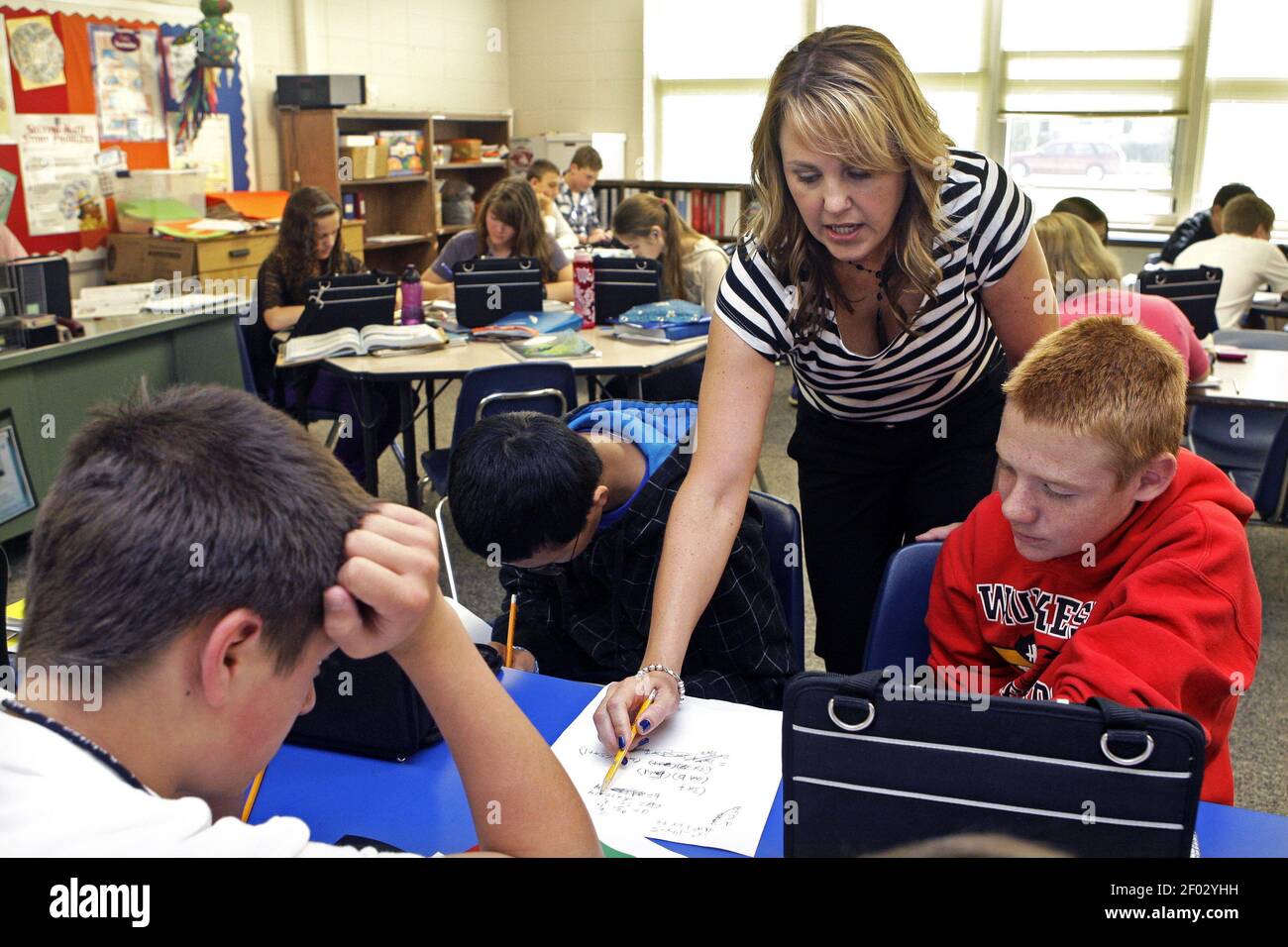 Kim Crosby helps student, Keegan Ehler, 14, right, with math assignment ...
