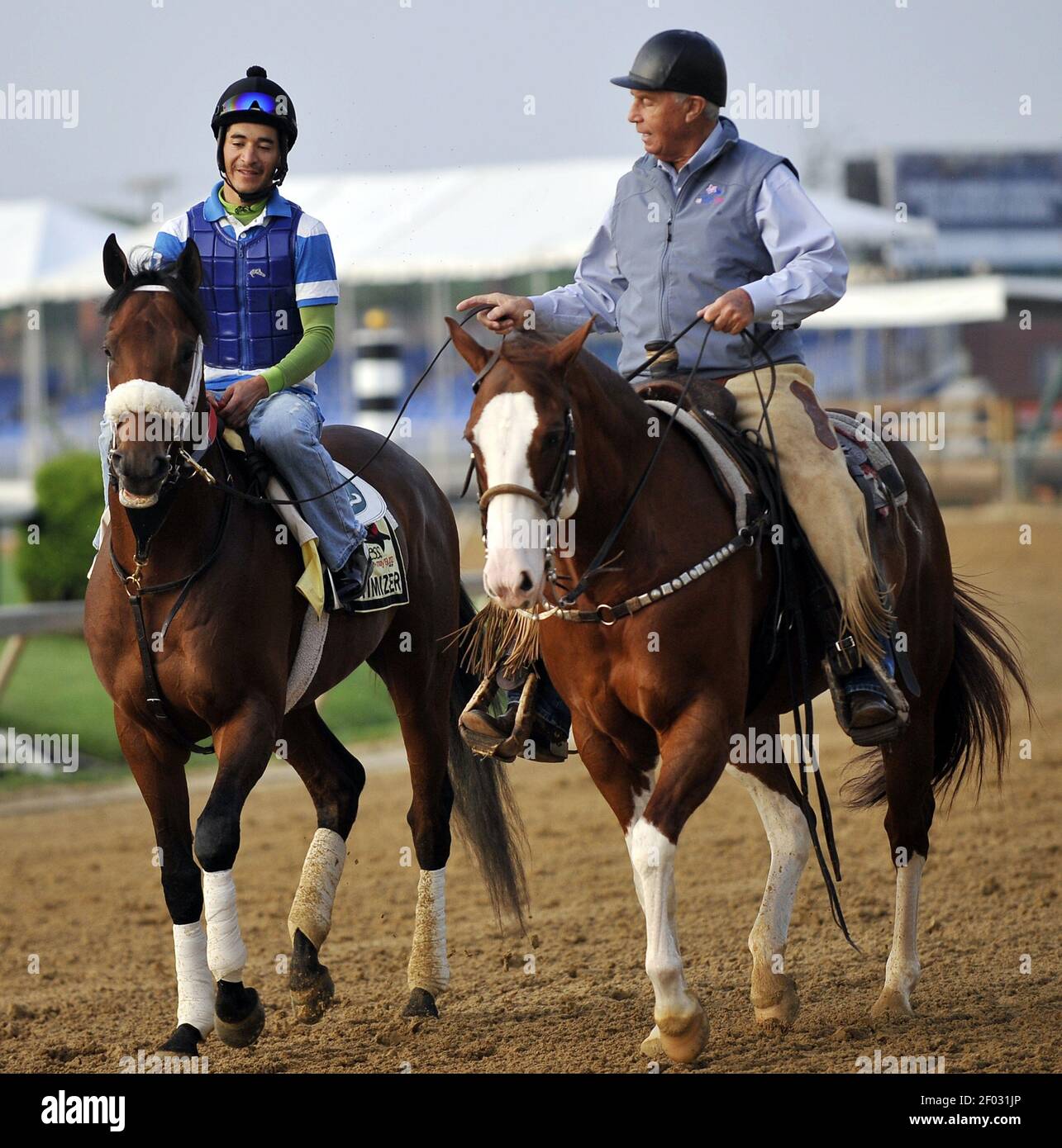 Joel Cano, aboard Optimizer, talks with D. Wayne Lucas after a morning ...