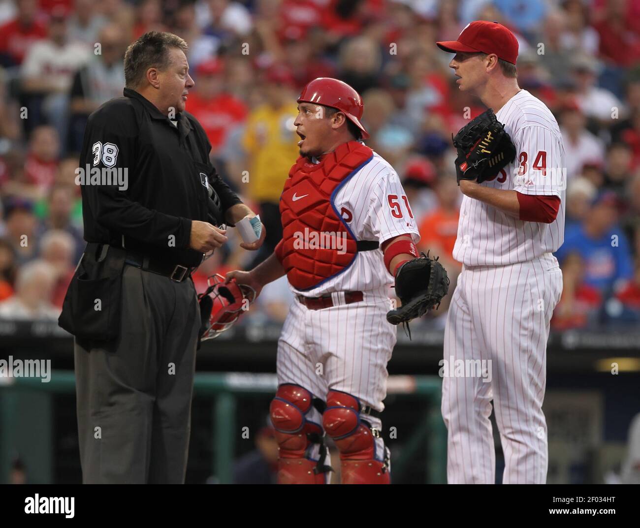 Philadelphia Phillies catcher Carlos Ruiz, center, argues his case with ...